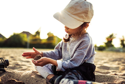 Little playing in the sand