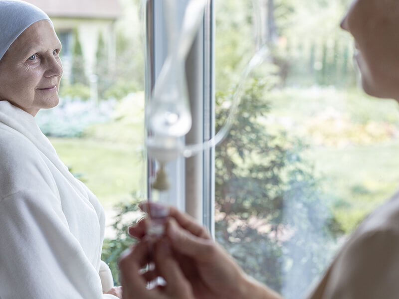 Elderly woman receiving cancer treatment